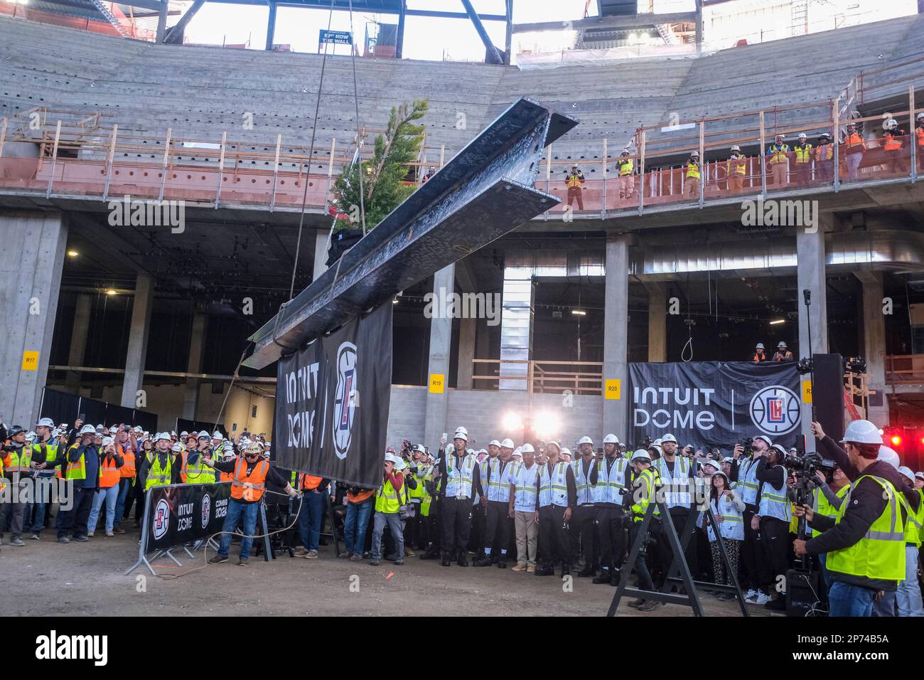 The final steel beam is raised during a topping-off ceremony at the Los ...