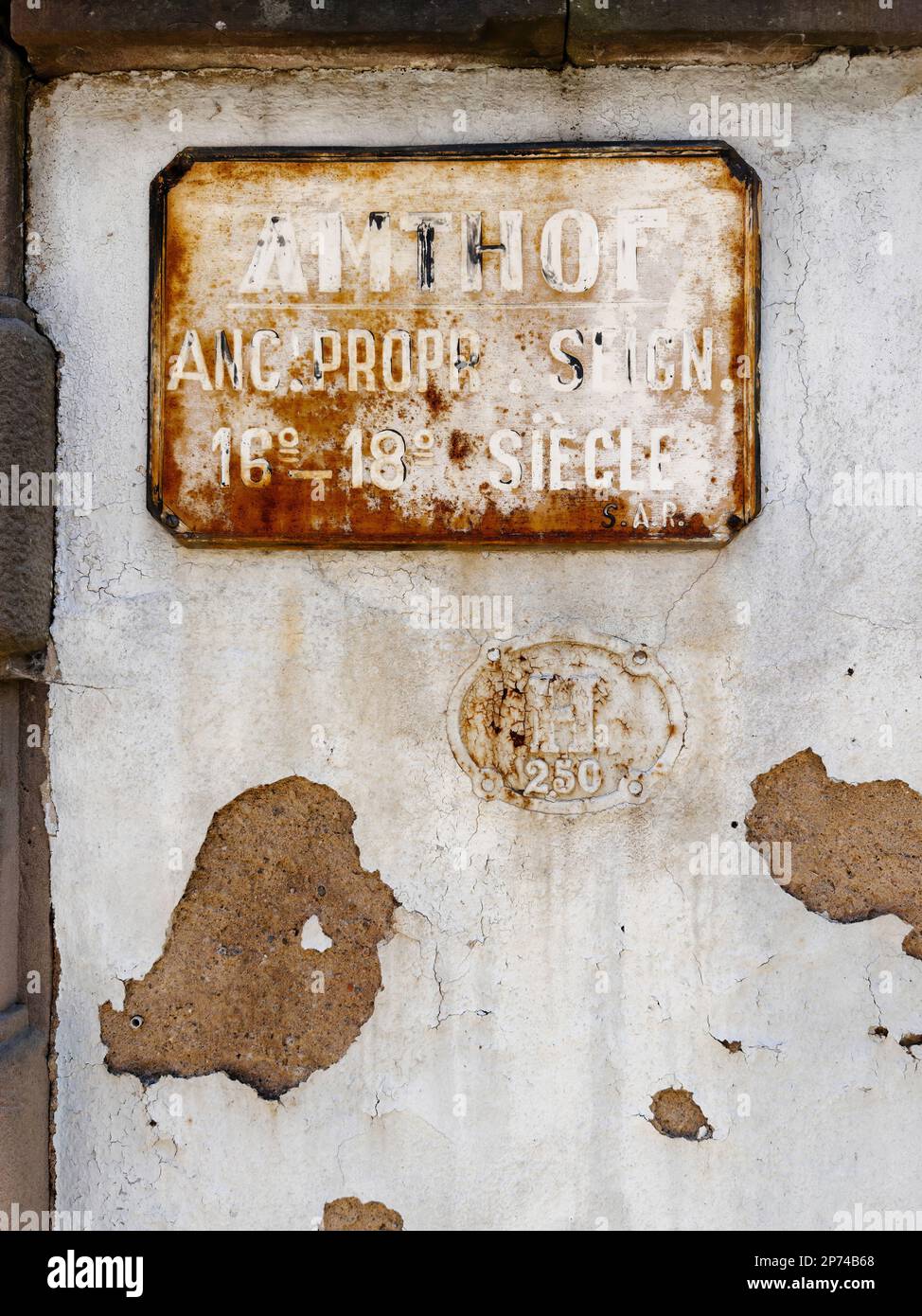 Old rusty signage on a building - touristic village information in ...