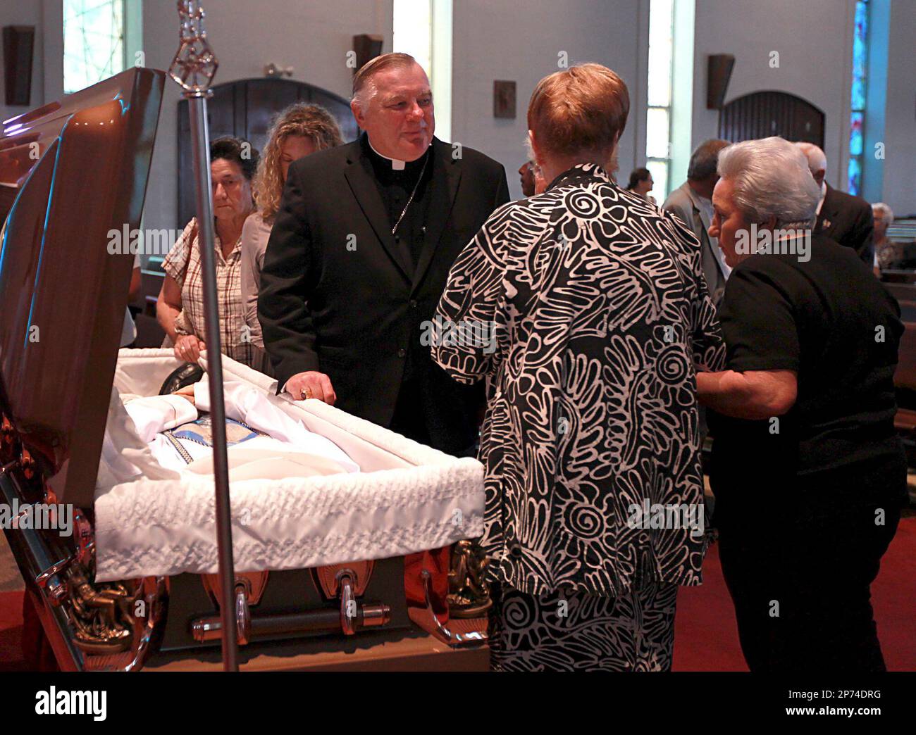 Archbishop Thomas Gerad Wenski, and Pilar Meurice, center, stand by the ...