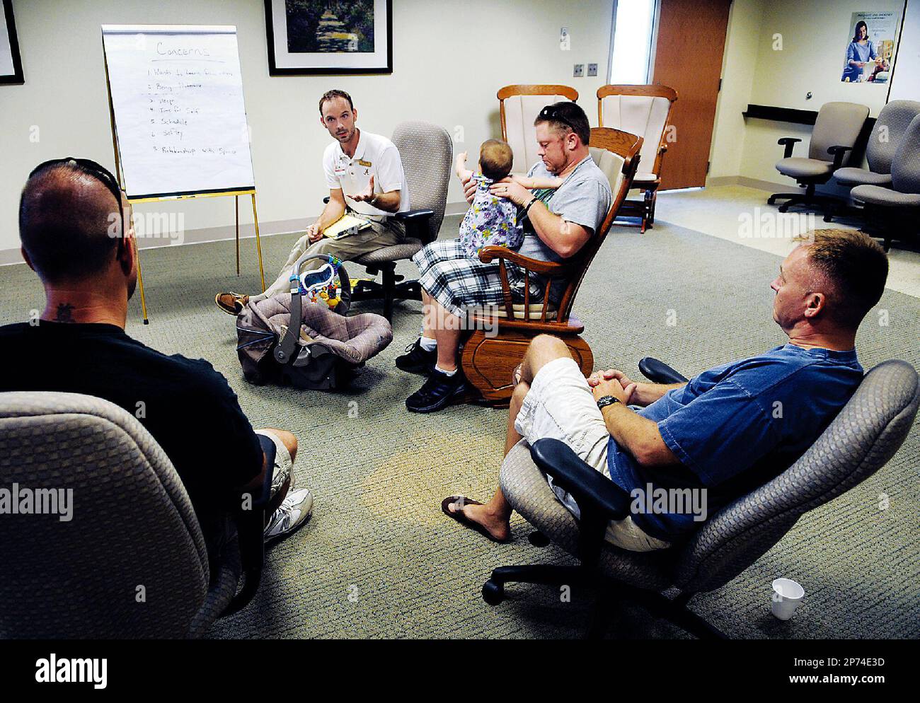 Jeremiah Dalton, second from left, leads a meeting about fatherhood ...