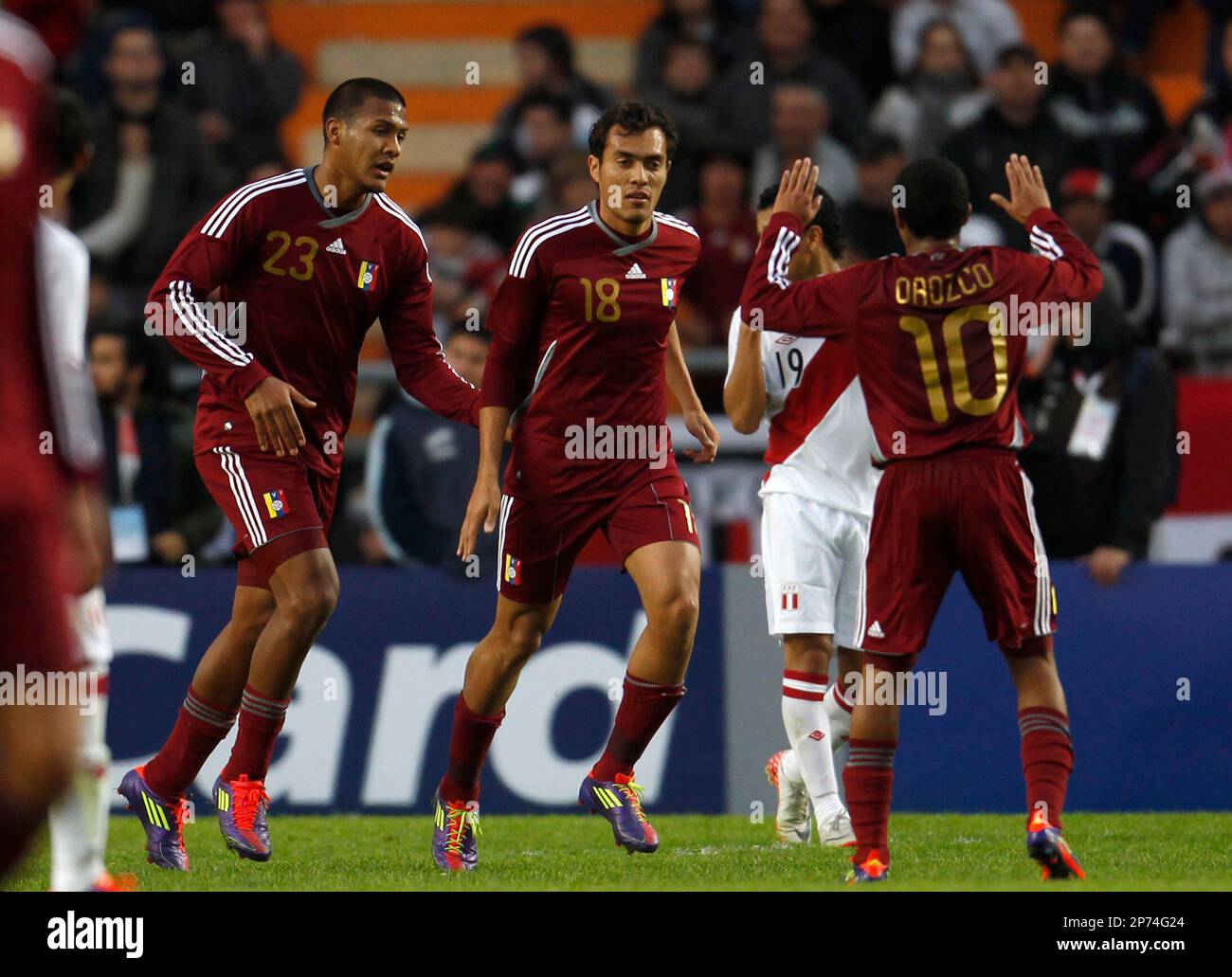 Venezuela's Juan Arango, center, celebrates his goal with teammates ...
