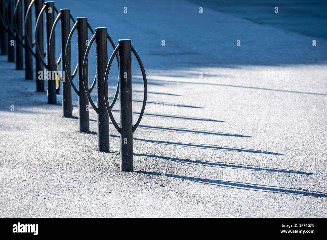 Long row of black metal bike racks Stock Photo - Alamy