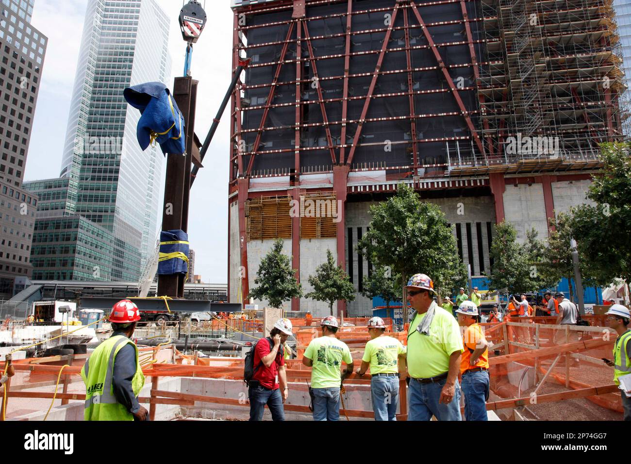 The September 11 cross is lowered by crane into a subterranean section ...