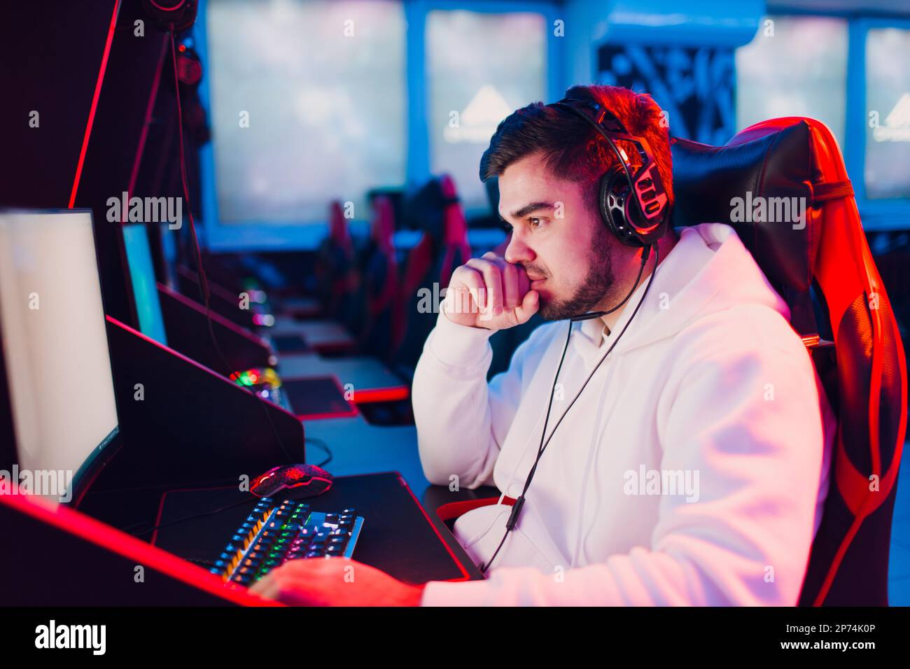 Guy playing gaming game on computer at game club Stock Photo - Alamy