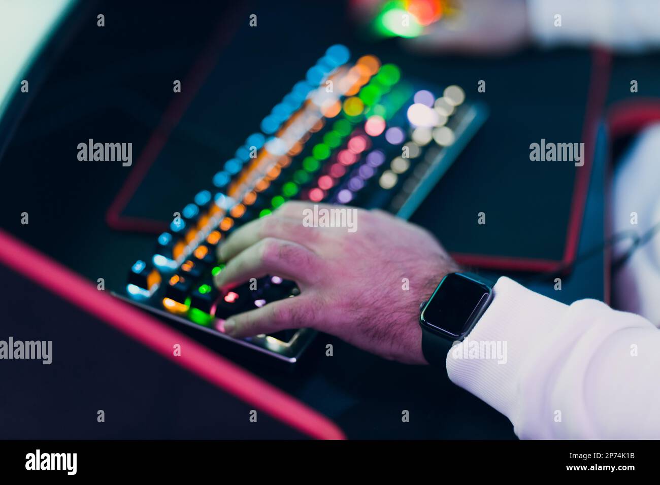 Guy playing gaming game on computer keyboard close up hands at club ...