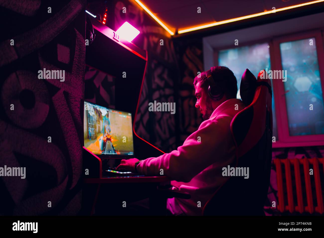 Guy playing gaming game on computer at game club Stock Photo - Alamy