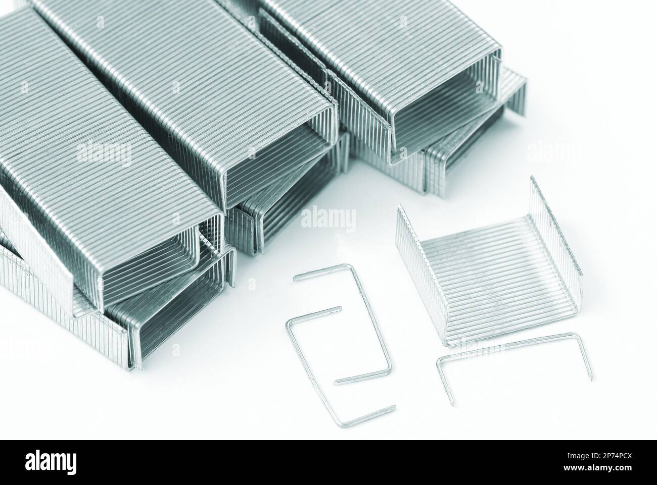 Heap staples wires on white background Stock Photo - Alamy