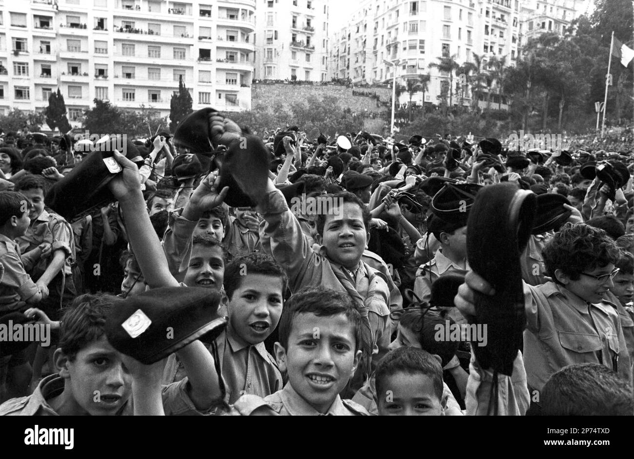 A group of children wave their berets during a farewell ceremony for ...