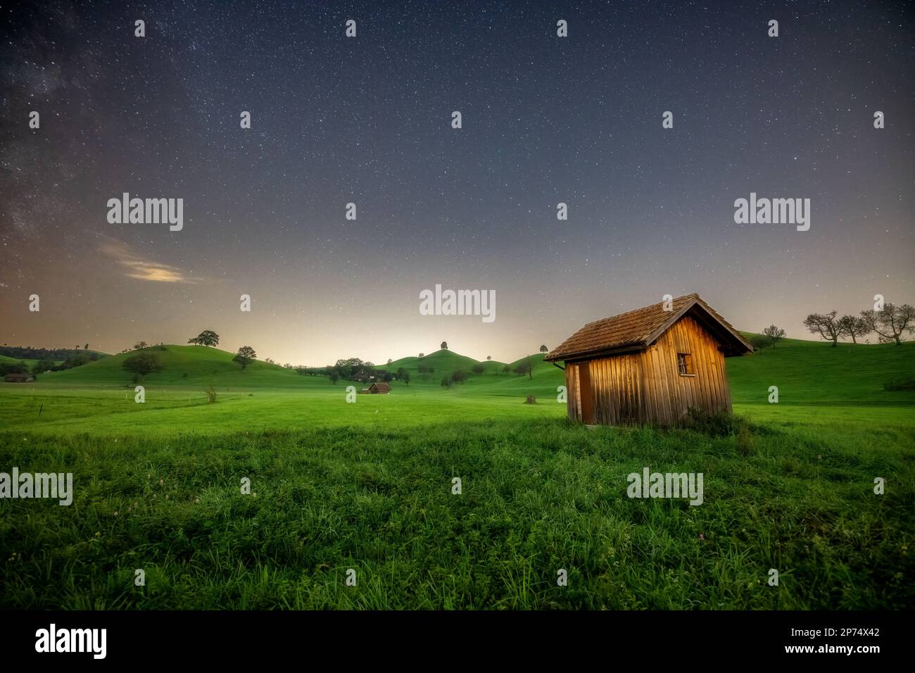 a small hut stands on a meadow sky the milky way can be seen Stock ...