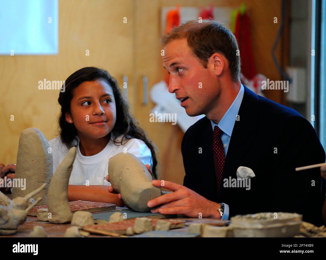 Prince William, the Duke of Cambridge, plays with clay with students in ...