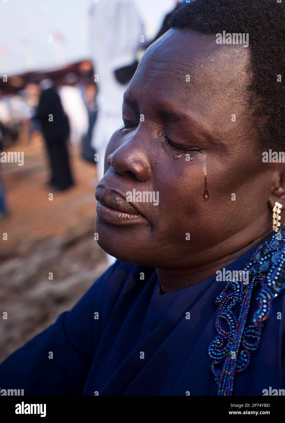 A woman cries tears of happiness at the statue of Dr. John Garang de ...