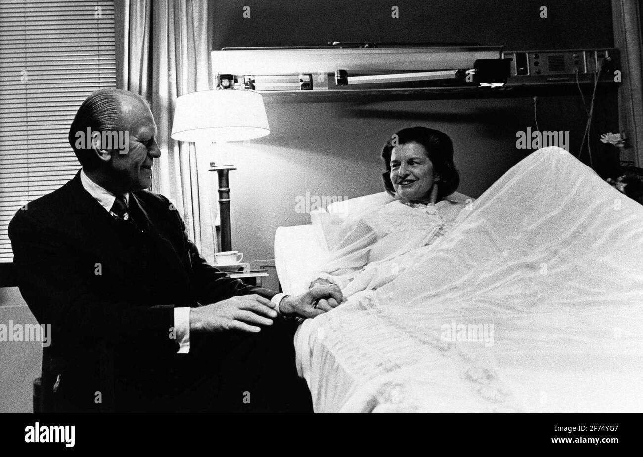 FILE - President Gerald Ford holds the hand of First Lady Betty Ford in ...