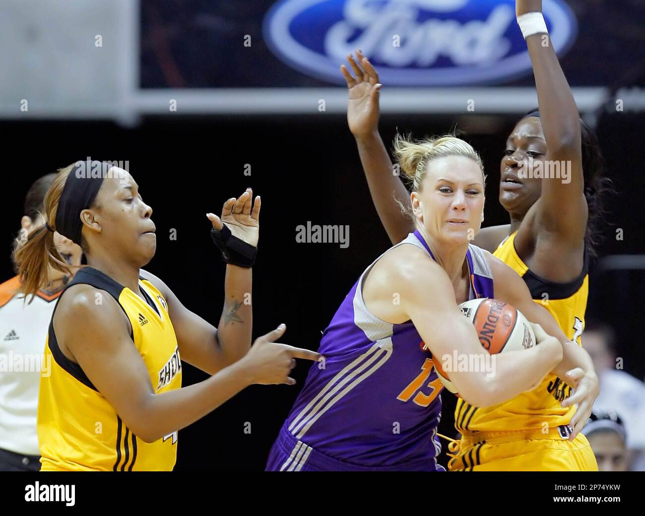 Phoenix Mercury forward Penny Taylor fight for the ball with Tulsa ...