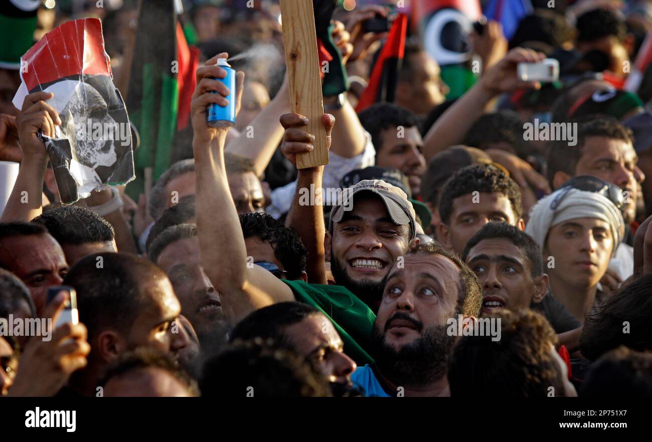 A Libyan man sprays deodorant in the crowd during a rally in the rebel ...