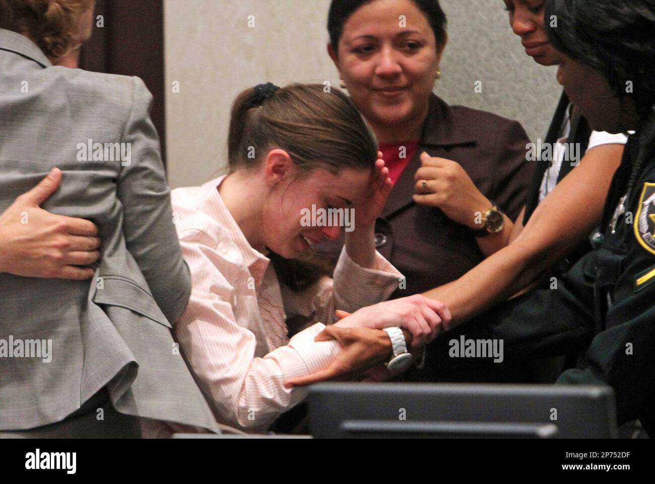 Casey Anthony, center, is overcome with emotion following her acquittal ...