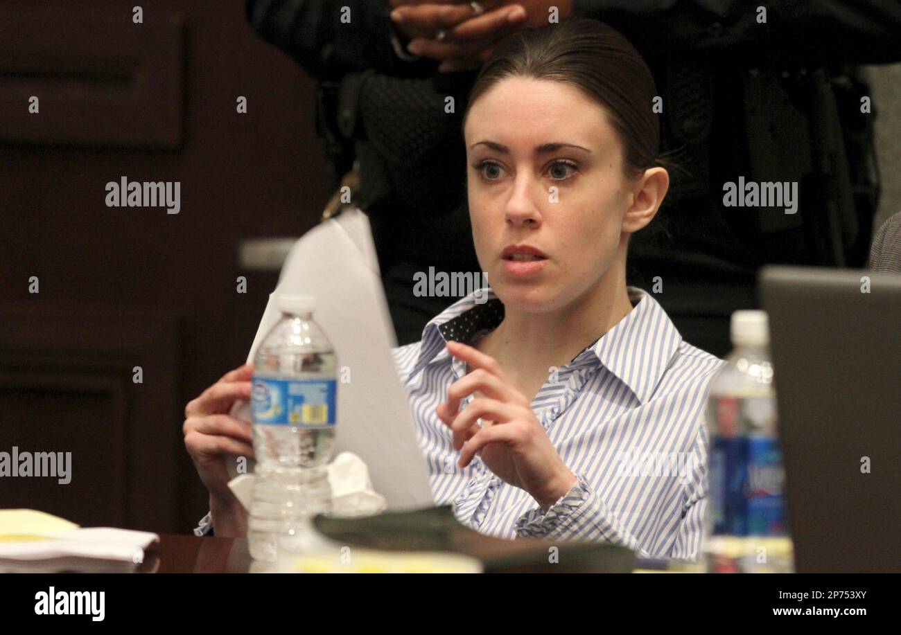 Casey Anthony goes over paperwork during a break on the final day of ...