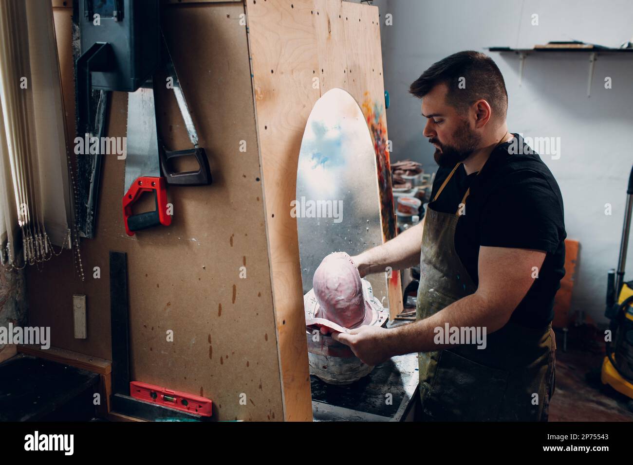 Artisan craftsman create mask based on plaster cast. Gypsum mold and ...