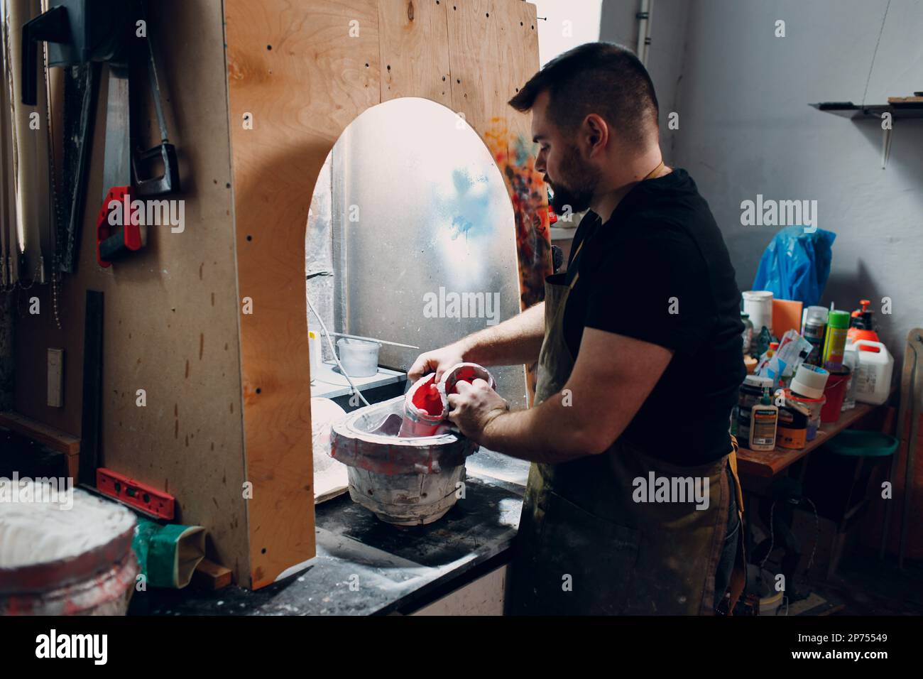 Artisan craftsman create mask based on plaster cast. Gypsum mold and ...