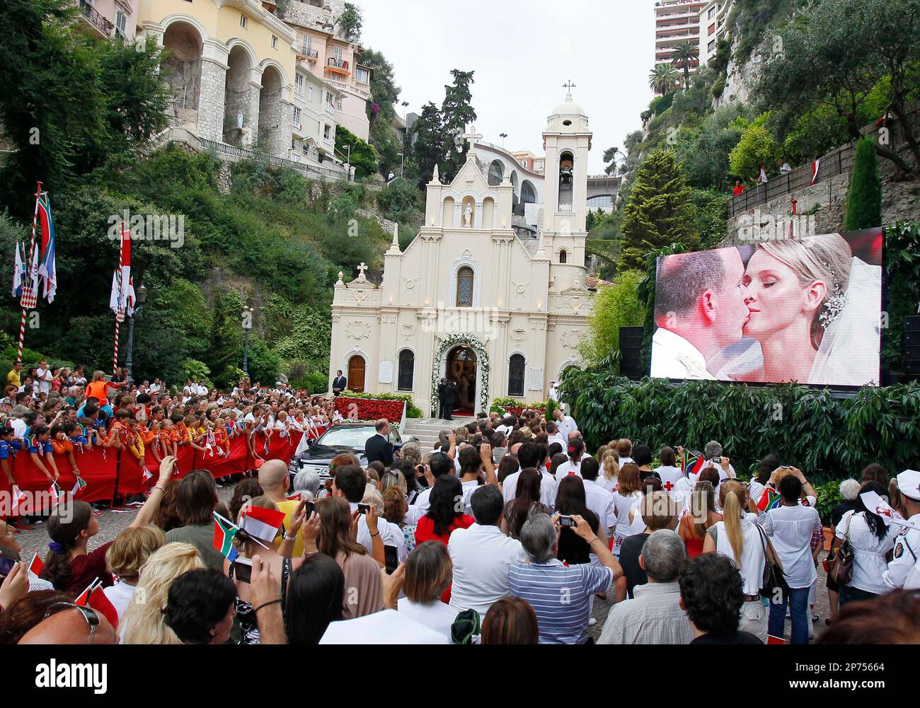 Princess Charlene and Monaco's Prince Albert II are watched on a big ...