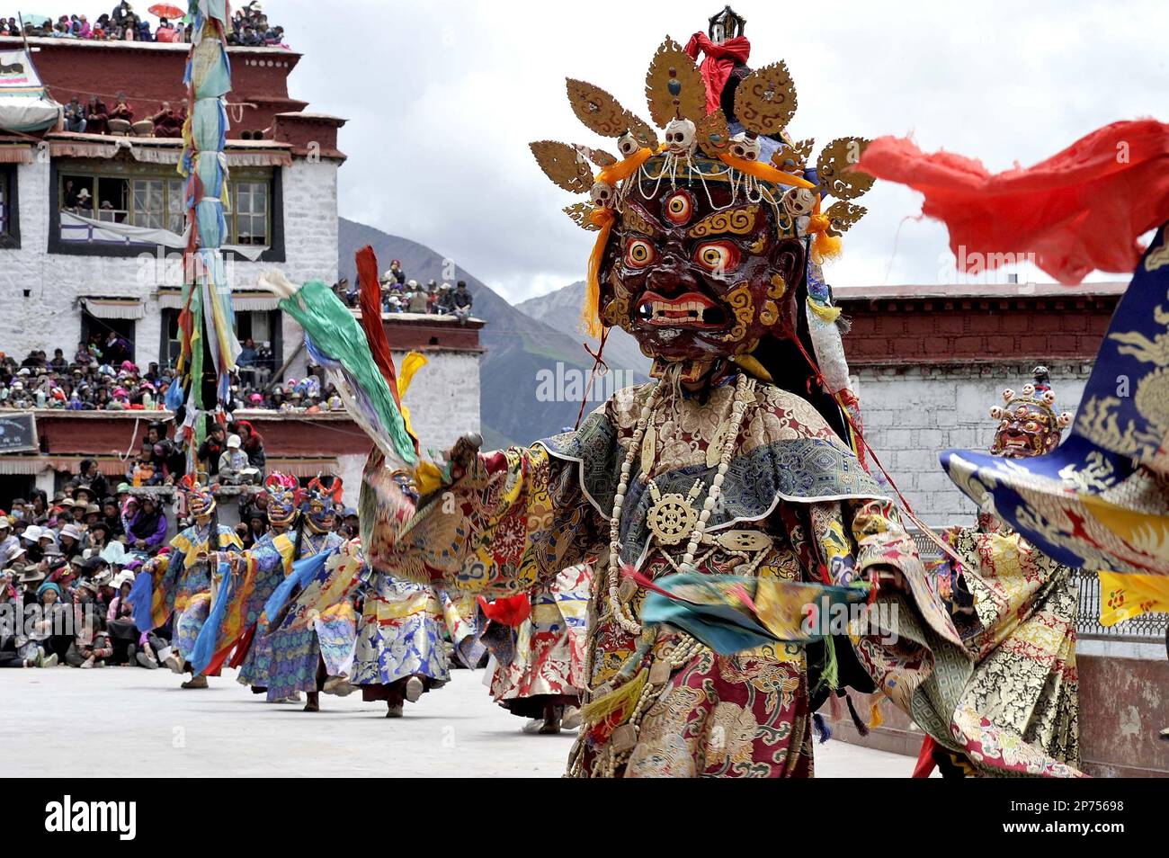 Tibetan monks dance during the annual summer dharma assembly at the ...