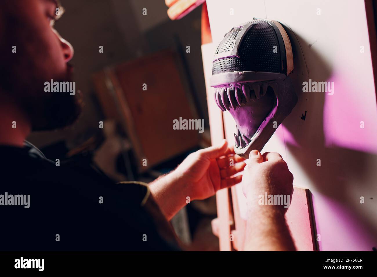 Artisan craftsman modeling mask based on plaster cast. Gypsum mold and ...