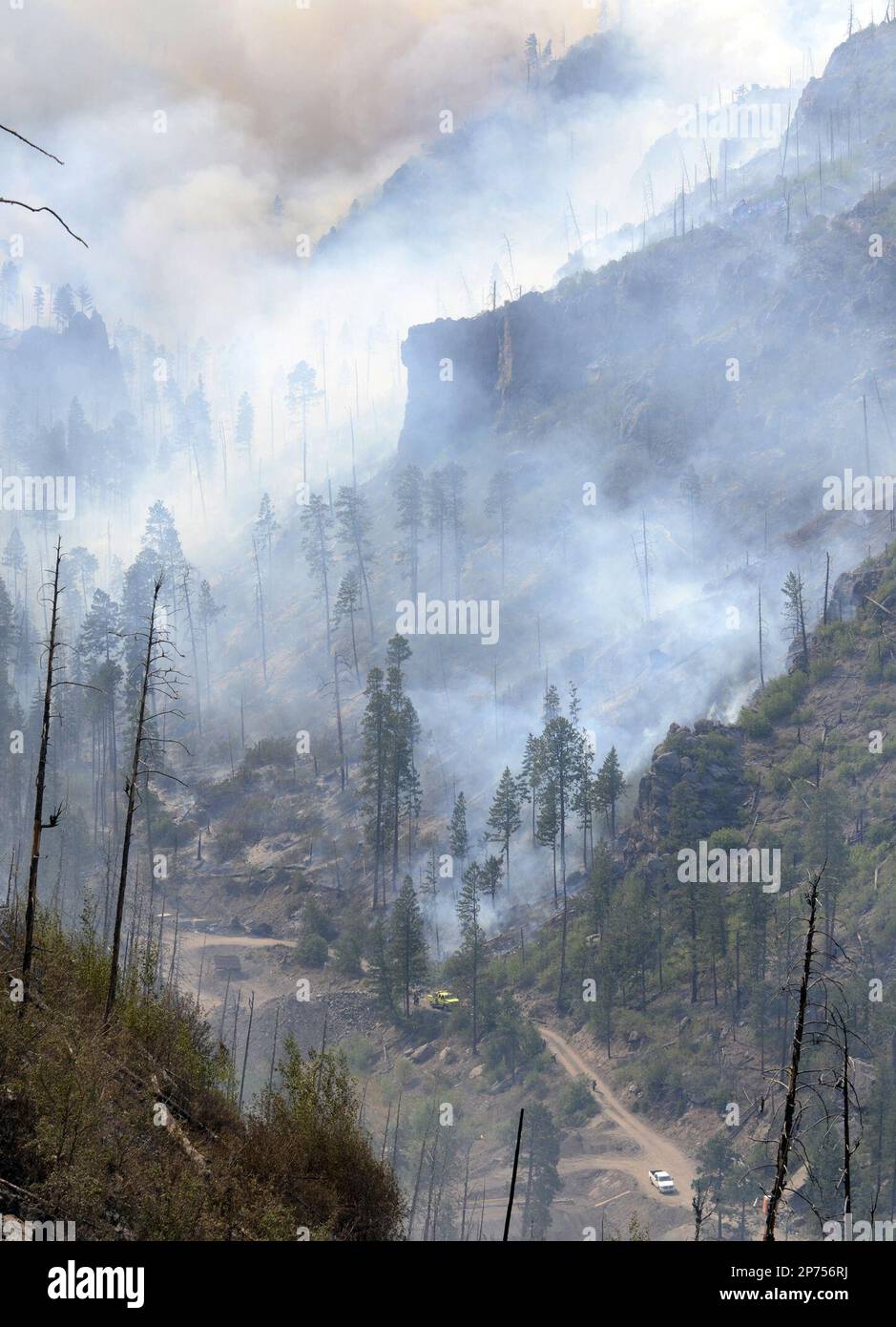 Fire fighting vehicles at the bottom of Los Alamos Canyon fight the Las ...