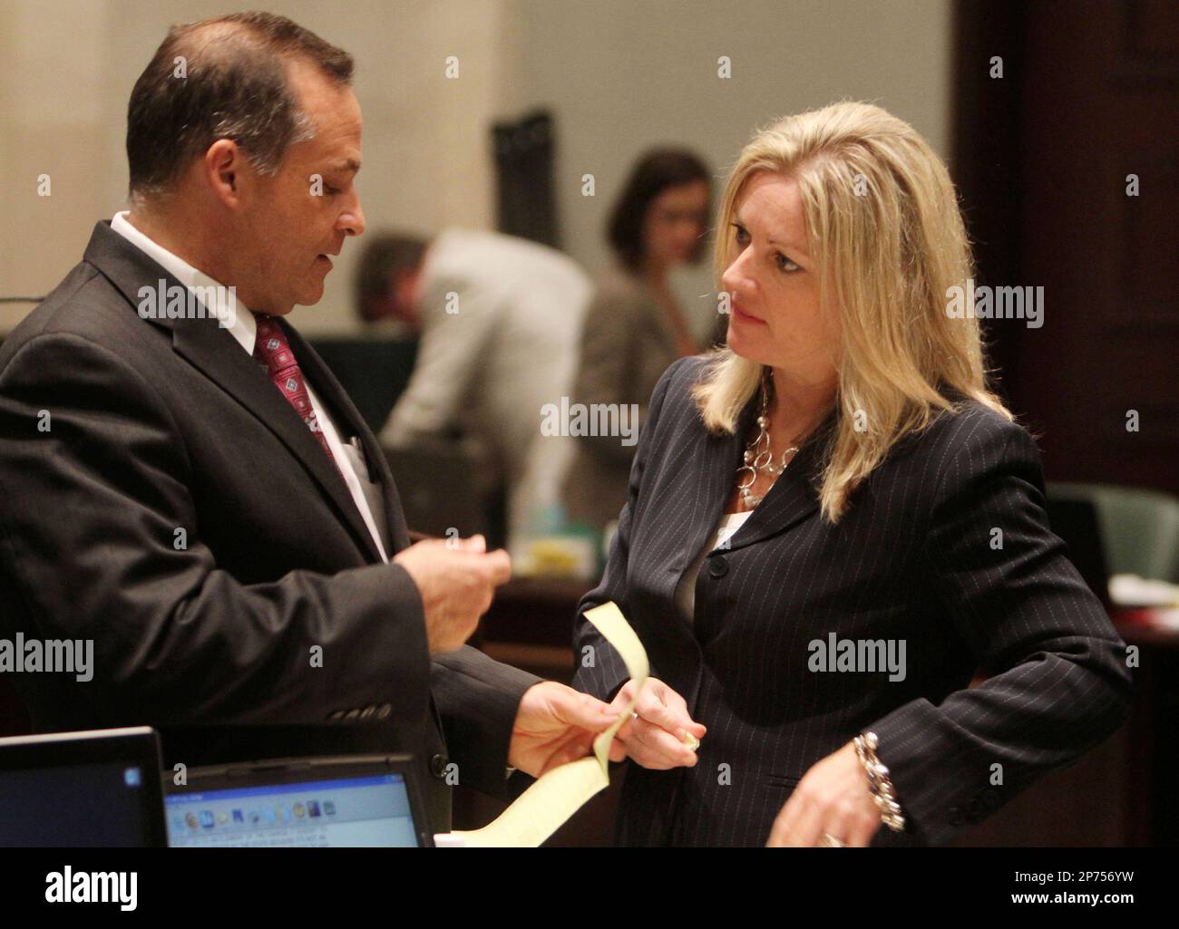 Assistant state attorneys Frank George, left, talks to Linda Drane ...
