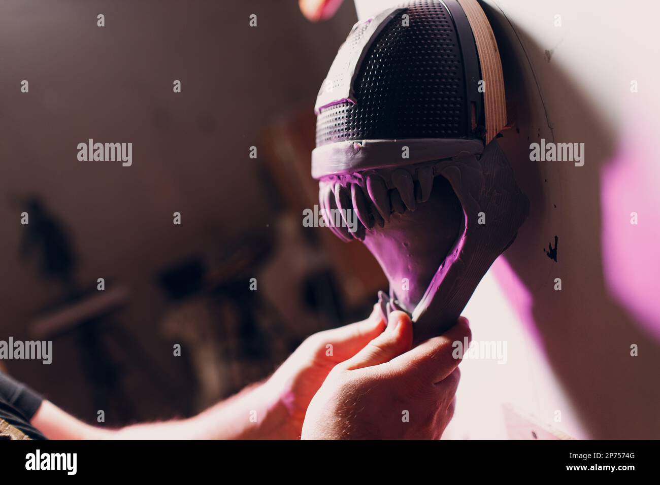 Artisan craftsman modeling mask based on plaster cast. Gypsum mold and ...