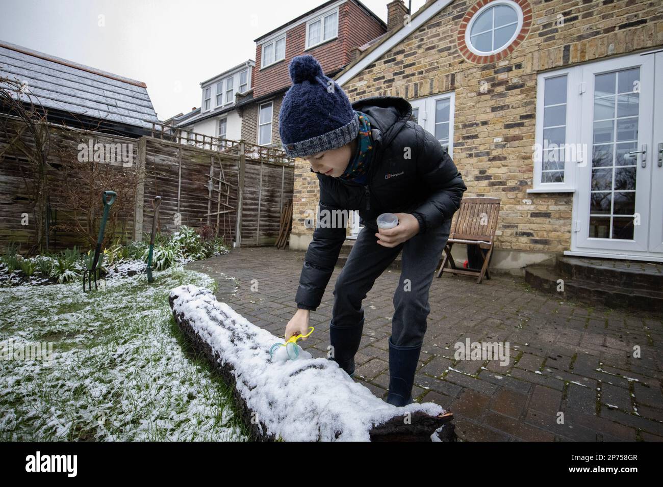London, England, UK 8th March 2023, A young boy collecting snow after a ...