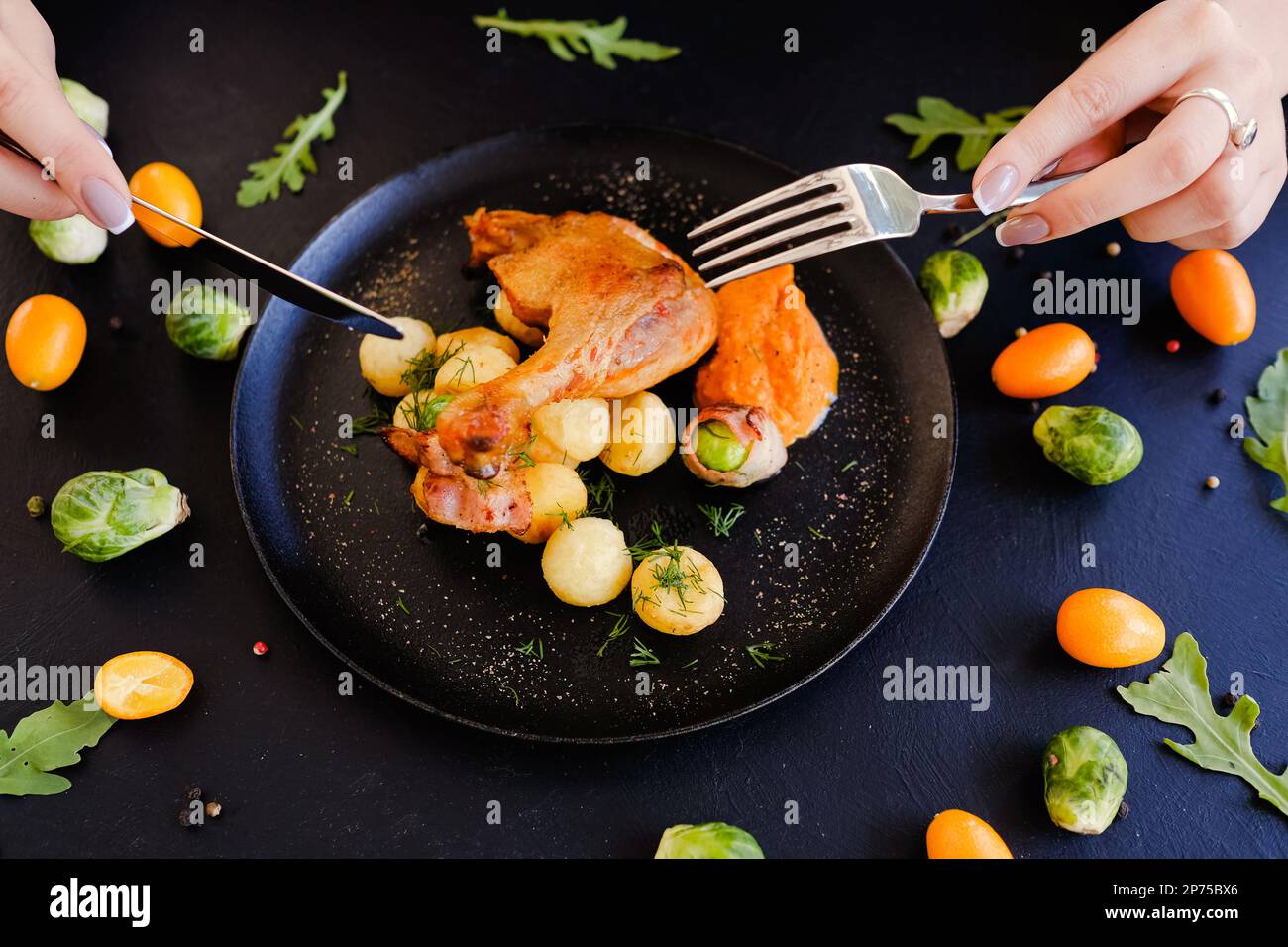 tasting ready made chicken leg dish breakfast Stock Photo - Alamy