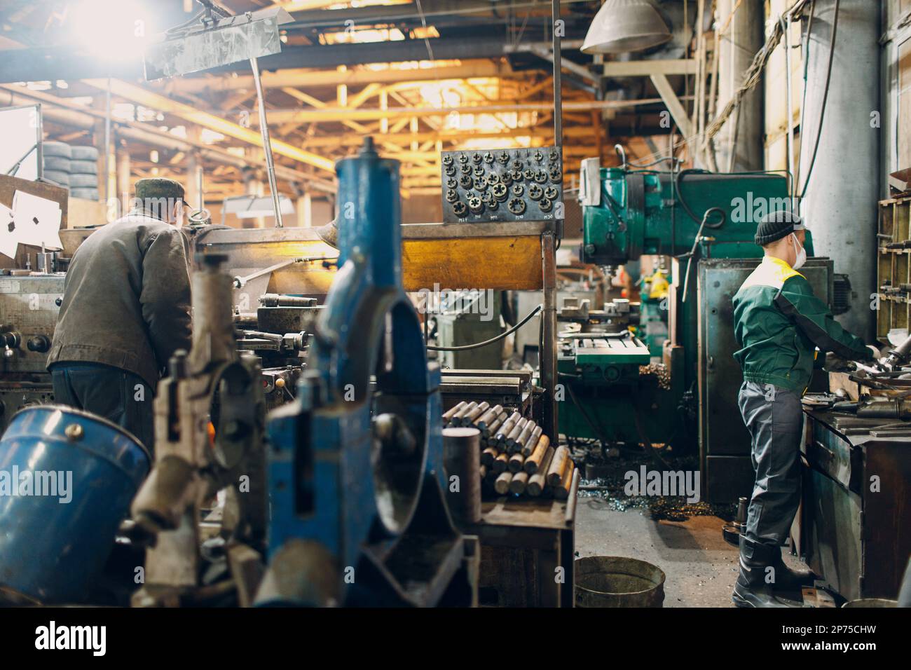 Workers working with steel structure parts construction at industrial ...