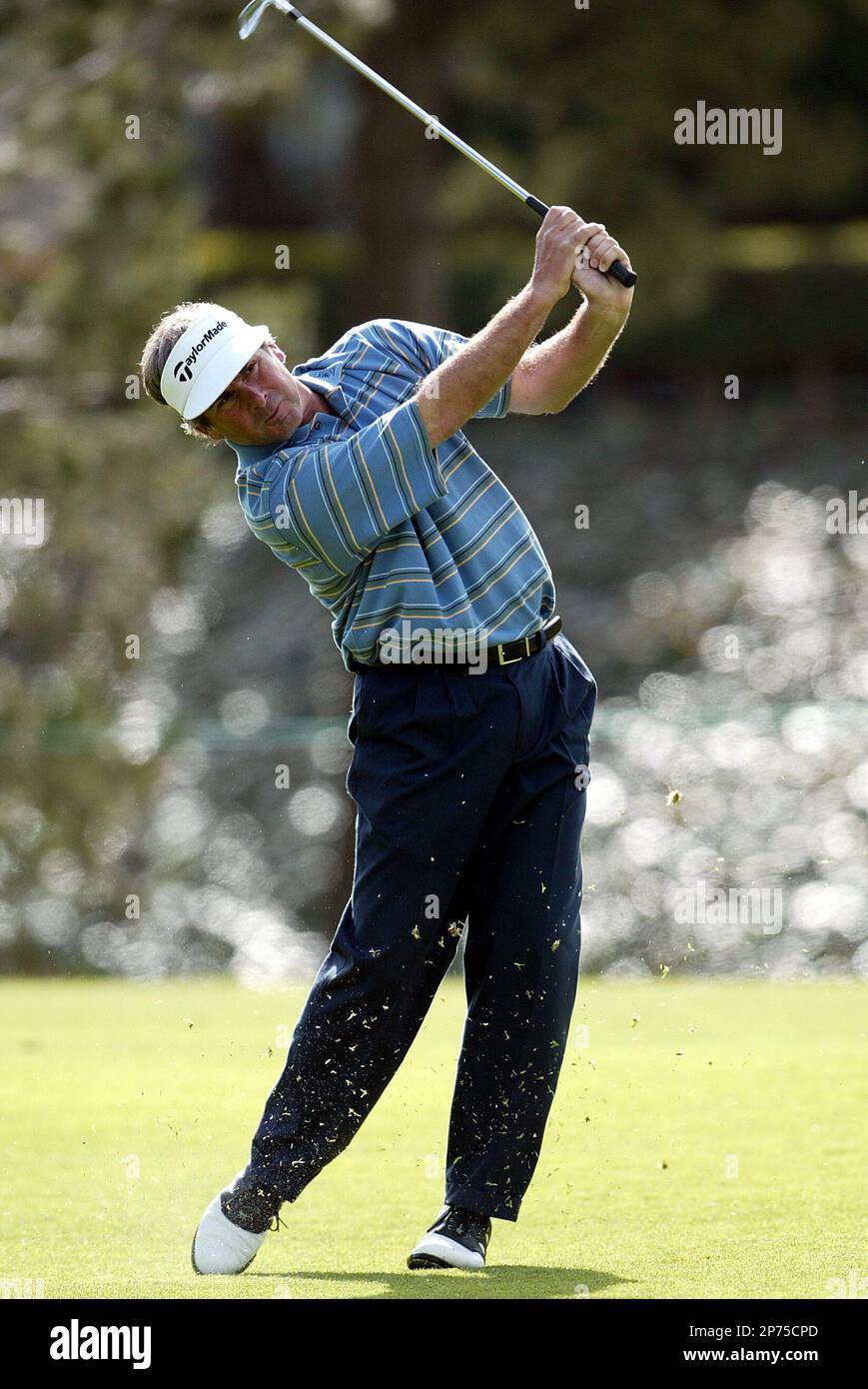 Professional golfer Fred Couples hits an iron shot in a round two match ...