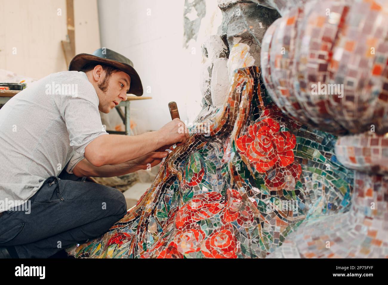 Man mosaics master in hat canadian making smalt glass mosaic panel ...