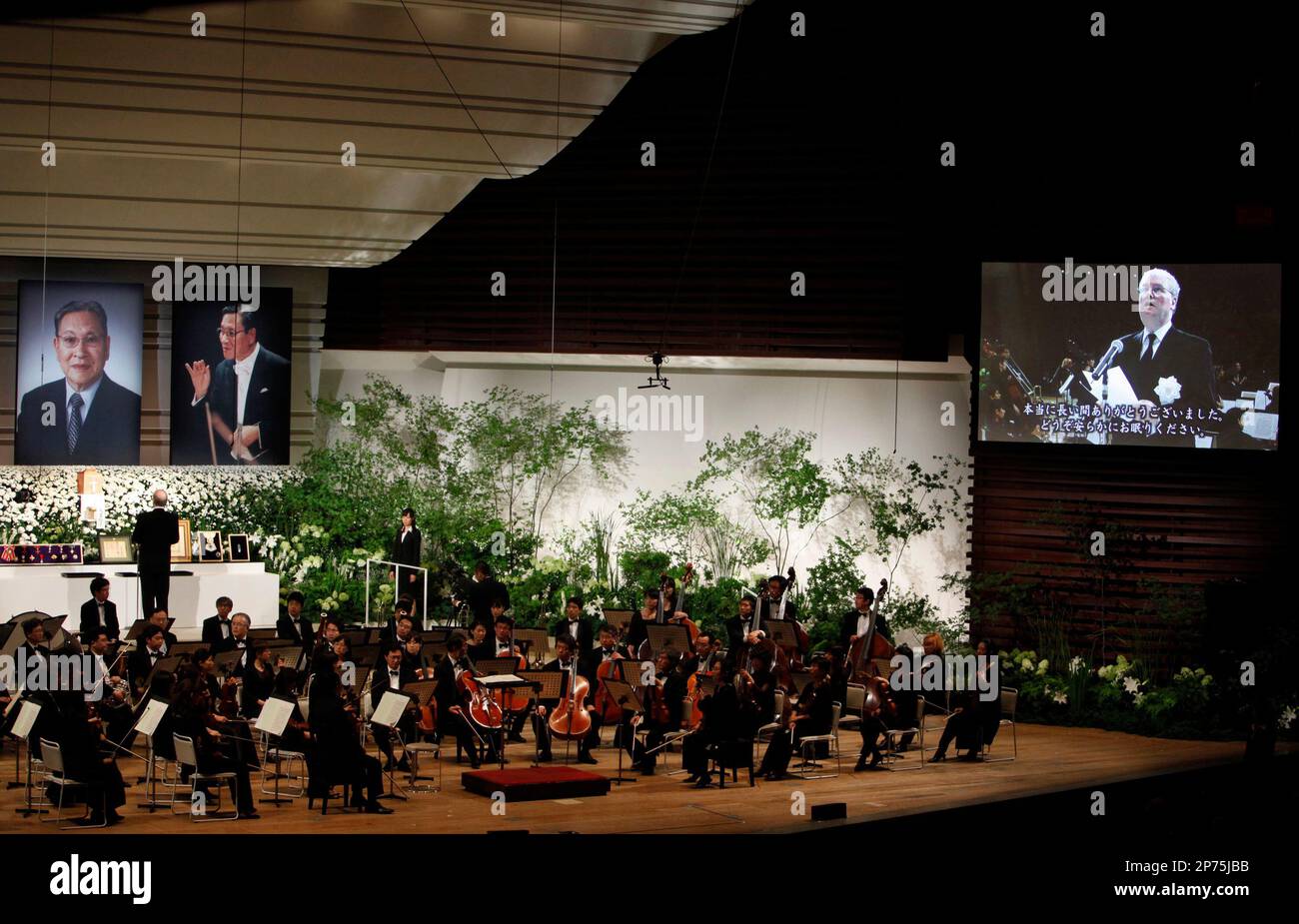 Sony CEO Howard Stringer, shown in a giant screen at right, makes a ...