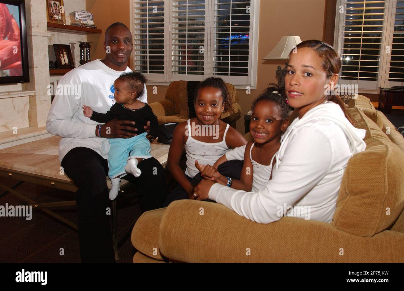 The Orlando Magic's Dee Brown, left, sits with his wife, Tammy, right ...