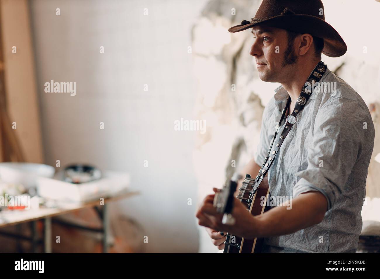 Male musician playing banjo sitting chair indoor Stock Photo - Alamy