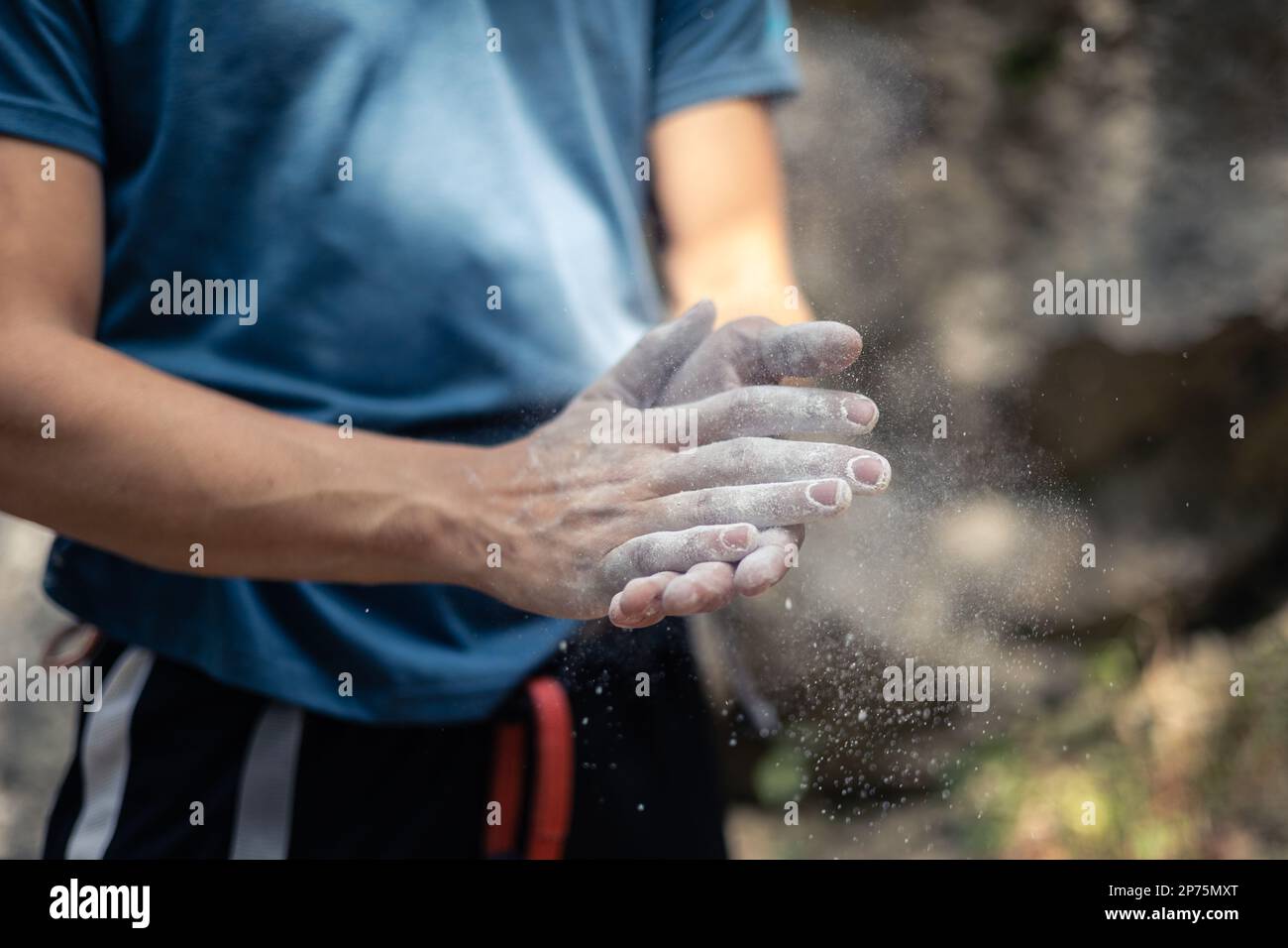 Magnesium particles flying around while climber clapping hands Stock ...
