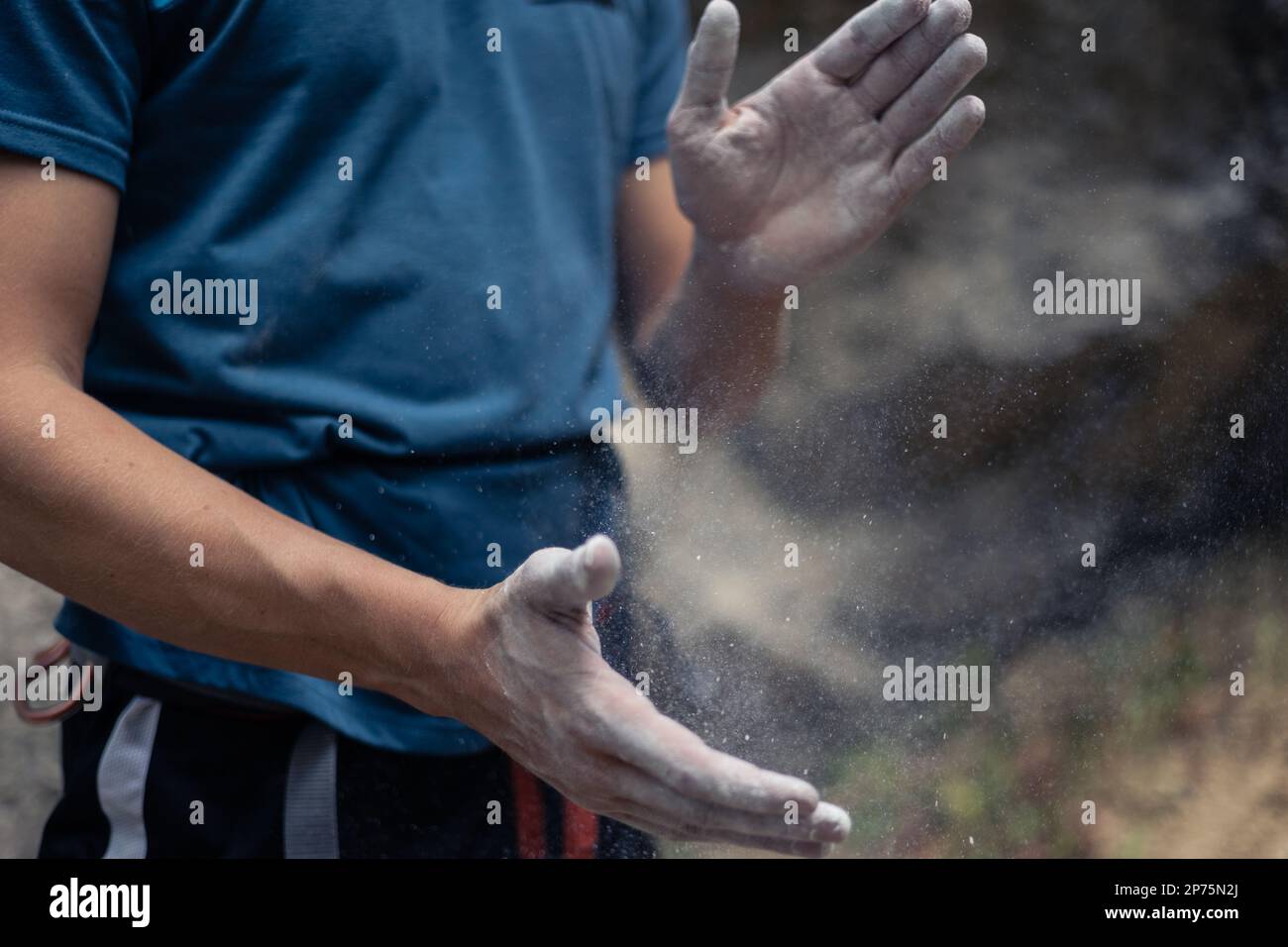Magnesium dust flying into the air as climber removes excess by ...