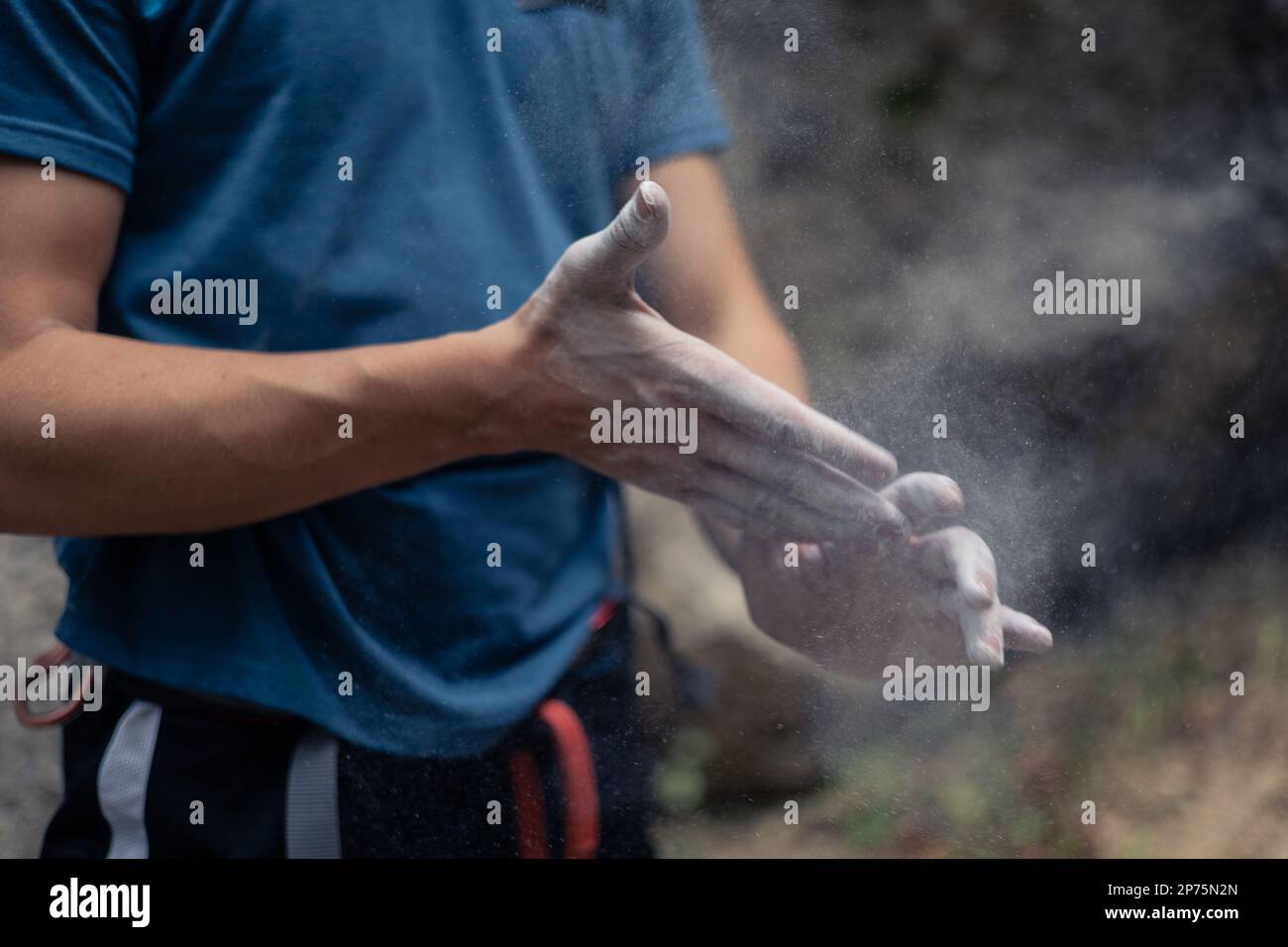 Climber rubbing hands to remove the excess of magnesium Stock Photo - Alamy