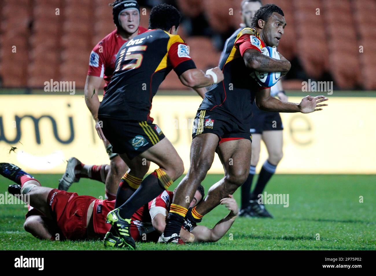 Chiefs' Save Tokula, right, fends of a tackle of Reds' Jono Lance, on ...