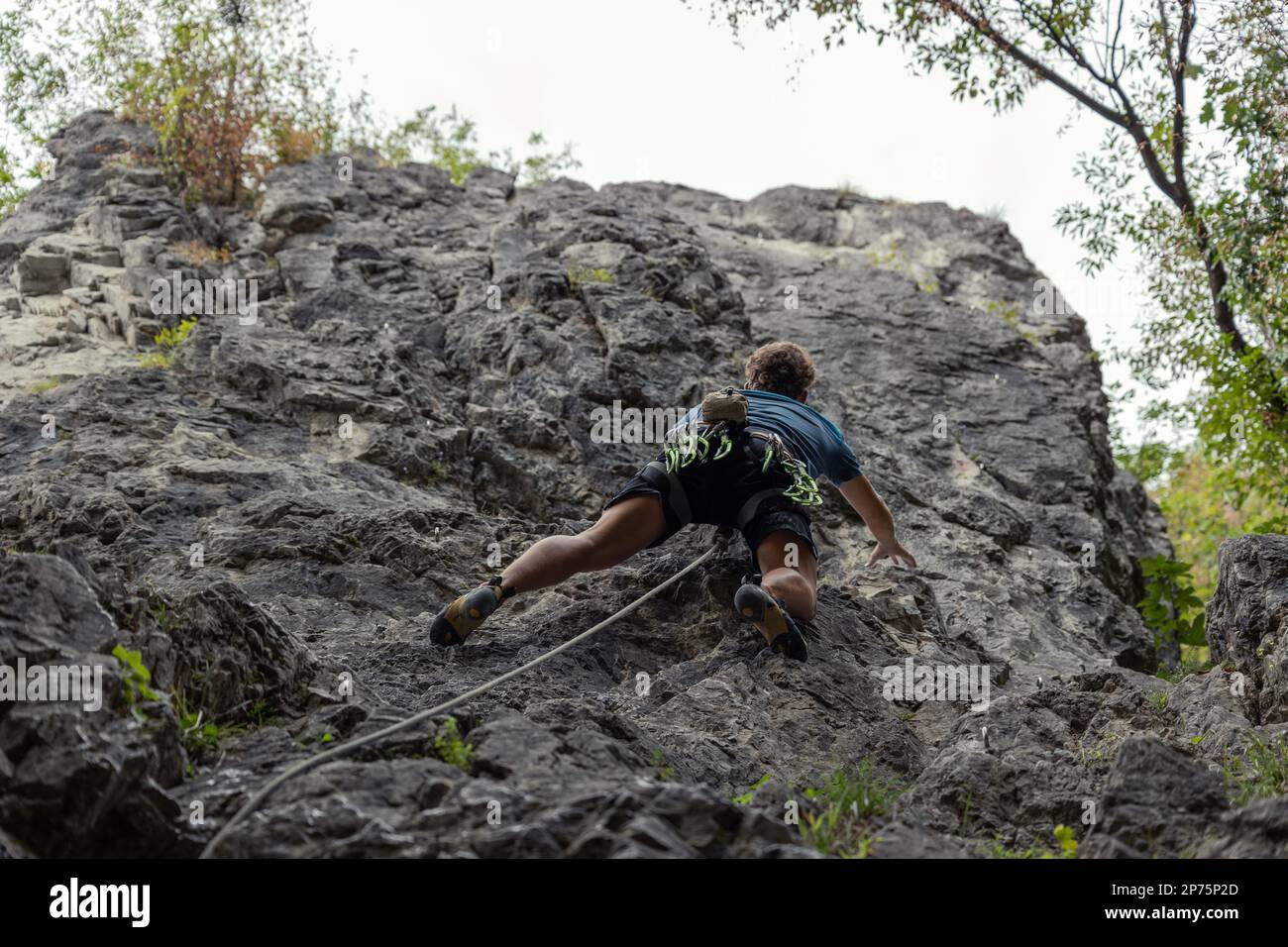 Climber climbing a rocky wall hi-res stock photography and images - Alamy