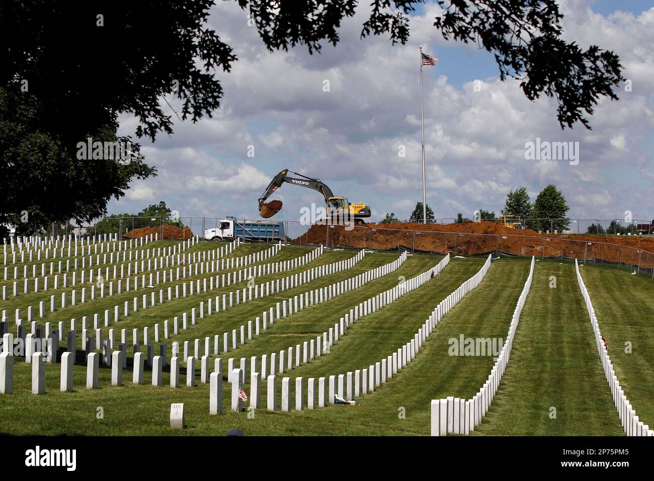Doug Finney, with Spanish Springs Construction, uses an excavator to ...