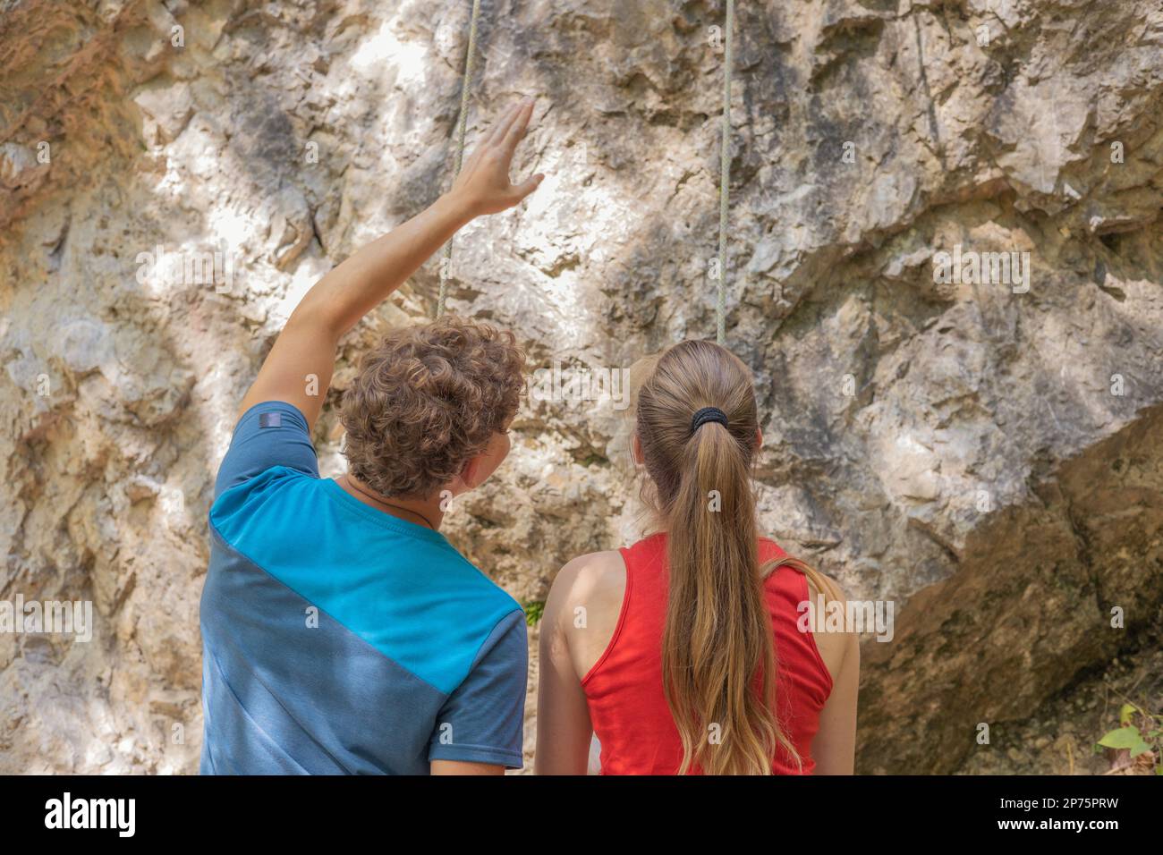 Climbing instructor showing the right way to successful climbing route ...