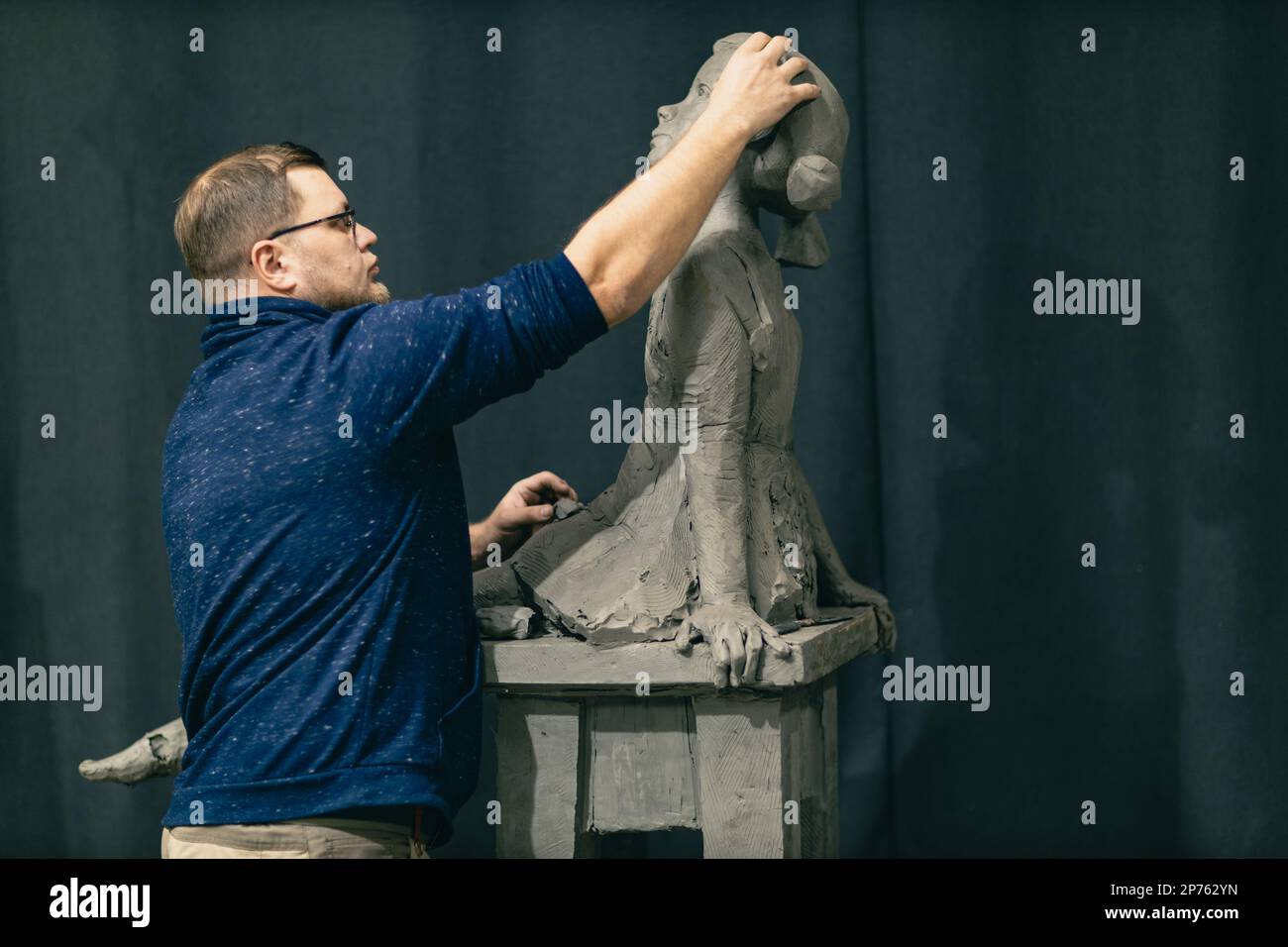 Man sculptor creates sculpt bust clay human woman sculpture. Statue ...