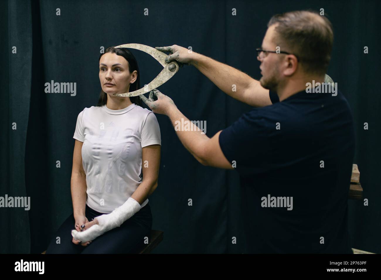 Man sculptor creates sculpt bust clay human measures compass woman head ...