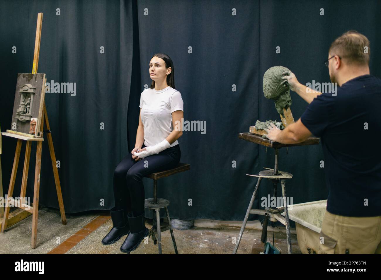 Man sculptor creates sculpt bust clay human woman sculpture. Statue ...