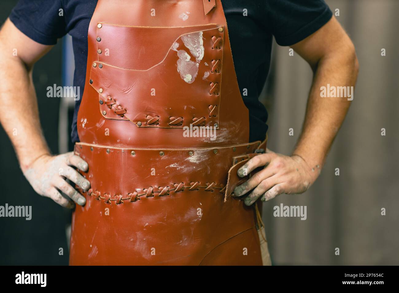 Man sculptor dressed leather apron with clay in hands. Statue craft ...
