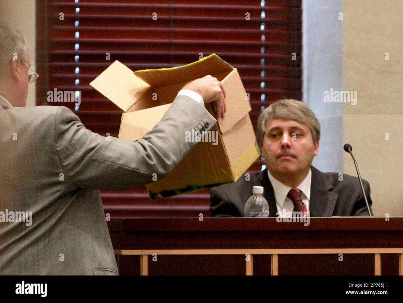 Assistant State Attorney Jeff Ashton hands evidence to Dr. Arpad Vass ...