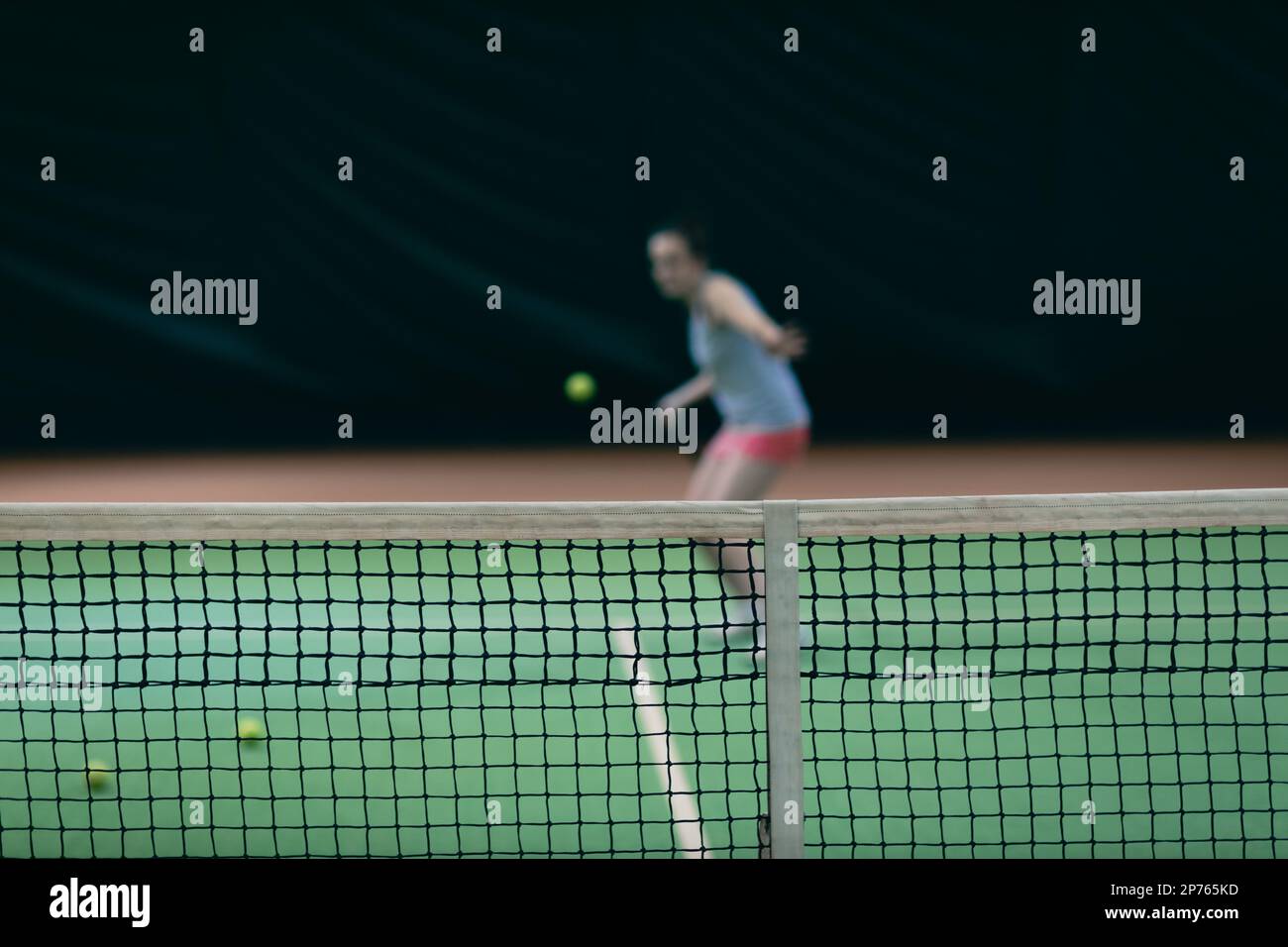 Tennis woman player playing training with racket and ball at court ...