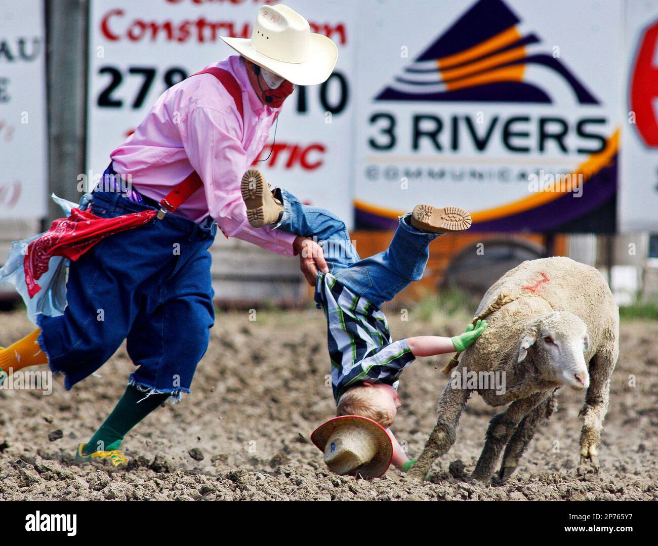 Rodeo clown Zane Drishinski grabs Noah Walter by the shirt tail before ...